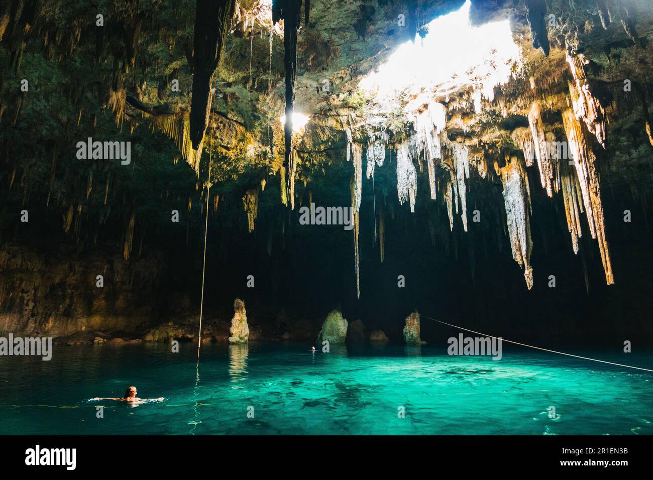 a swimmable cenote – a natural underground pool caused by a sinkhole in ...