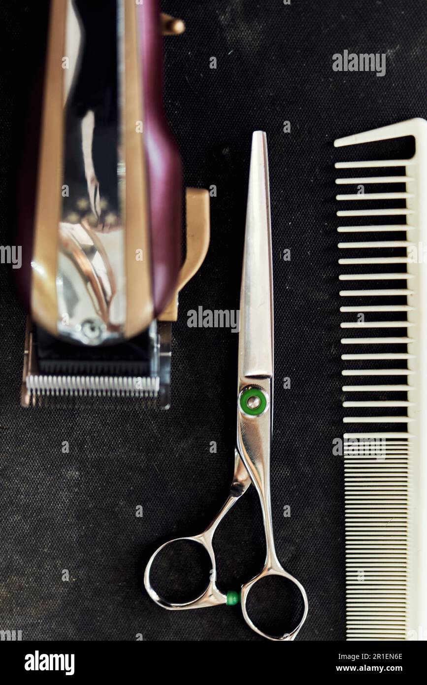 A cut above the rest. Still life shot of shear scissors, a hair comb ...