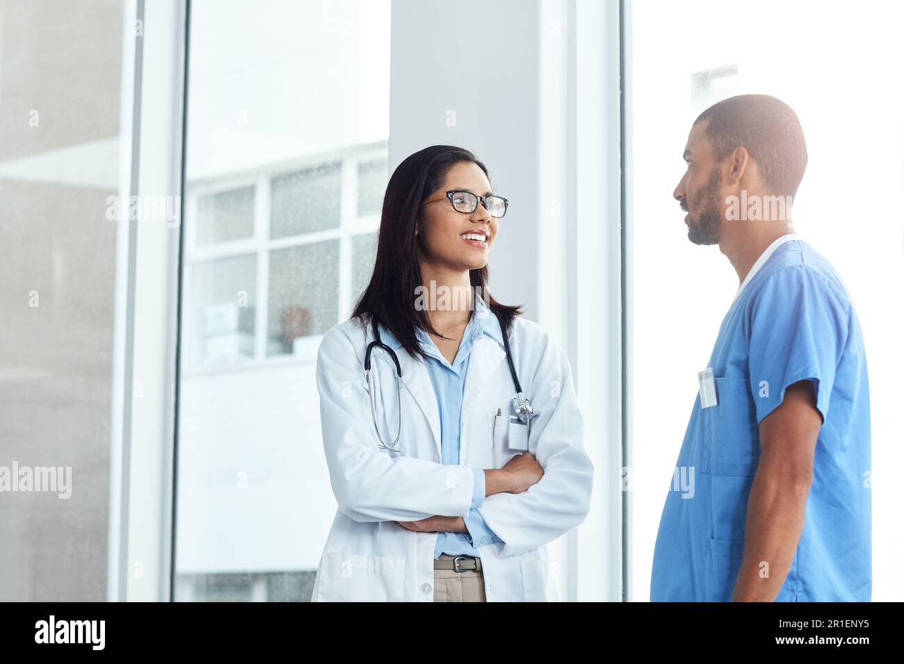 Patient care is a team task. two young doctors having a discussion in a ...