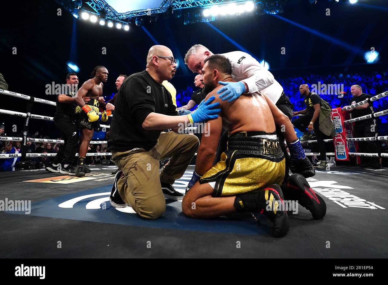 Joe Fournier is checked by the ringside doctor after being knocked out ...
