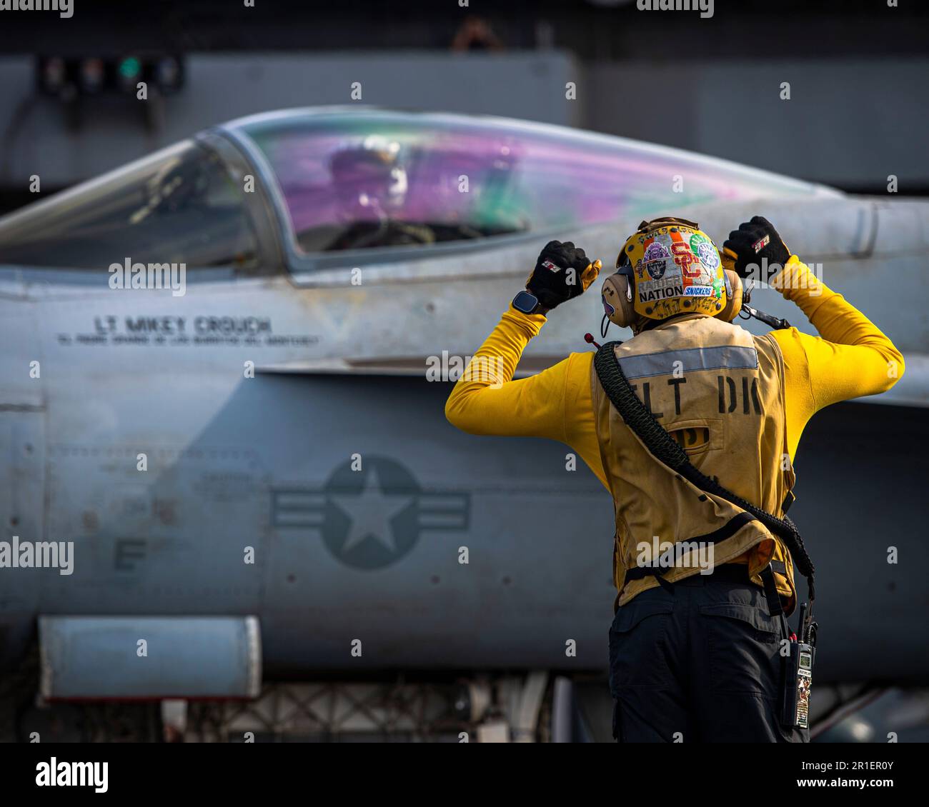 230513-N-MH015-1244 PHILIPPINE SEA (May 13, 2023) A U.S. Navy Sailor directs an F/A-18E Super ...