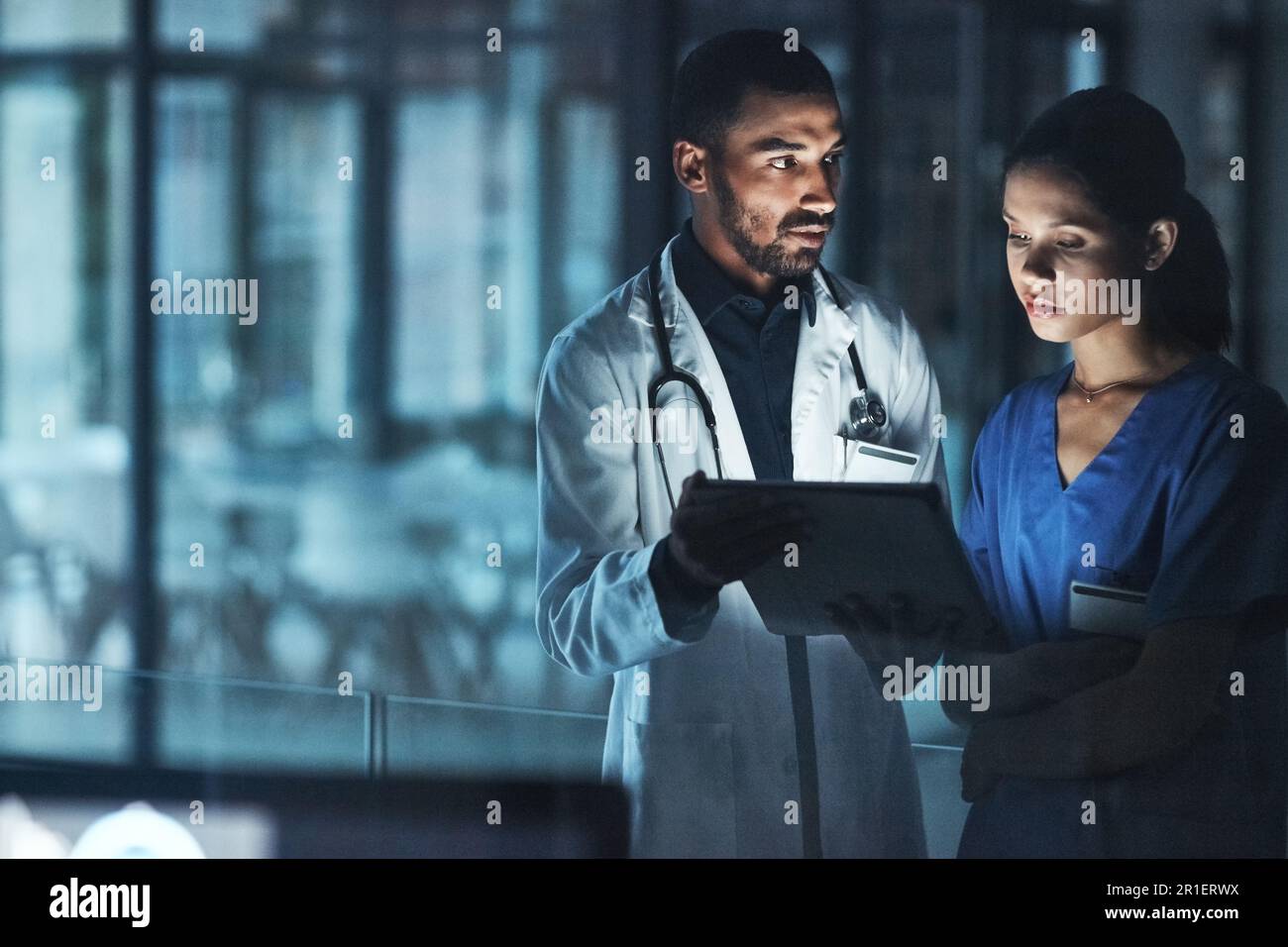 Patient care is a 247 commitment. two young doctors using a digital ...