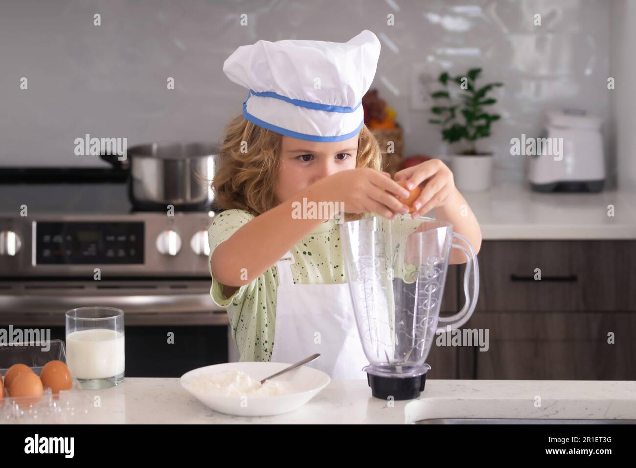 Children cooking in the kitchen. Funny kid chef cook cookery at kitchen ...