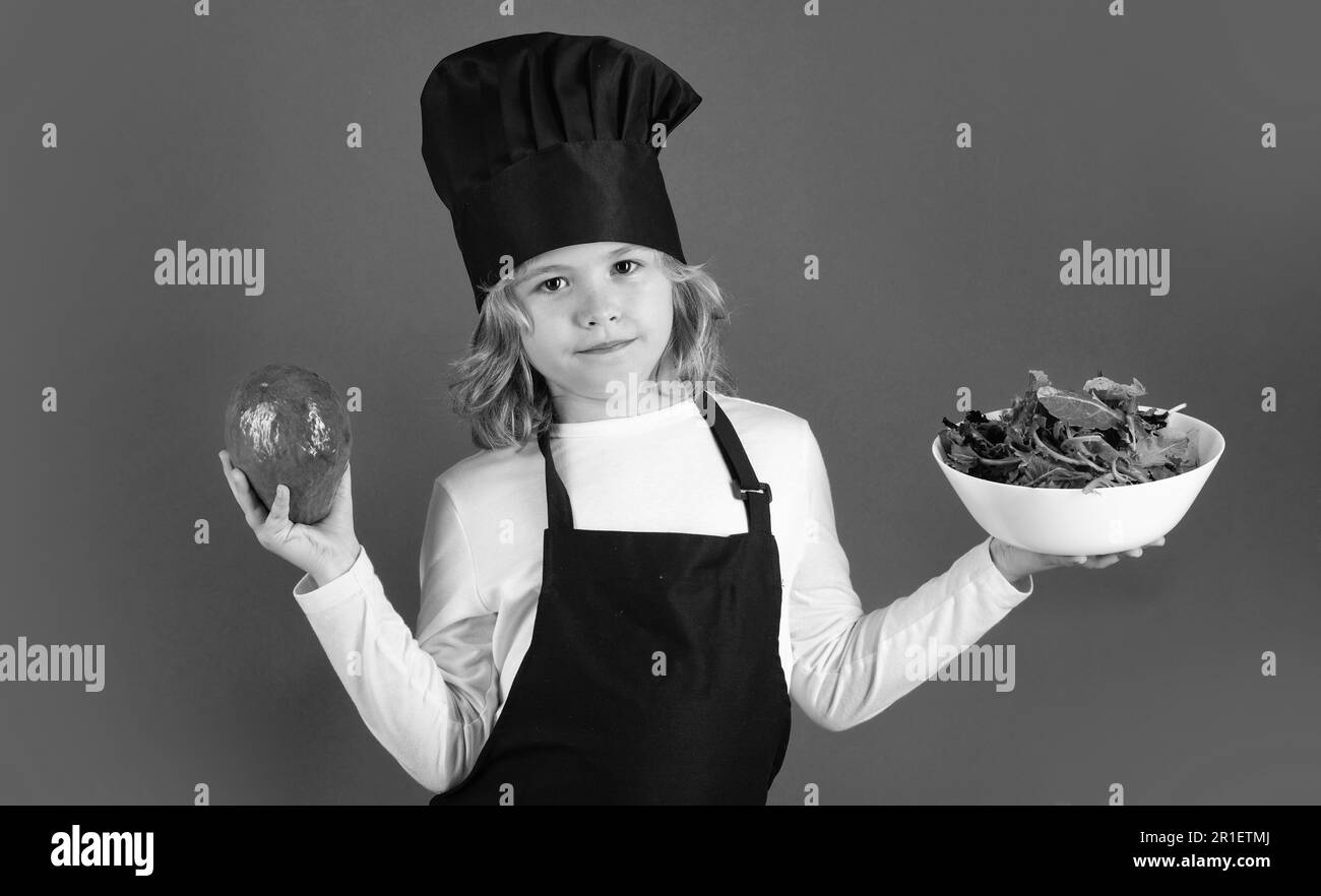 Kid cook with avocado and vegetable. Child in cook uniform. Chef kid ...