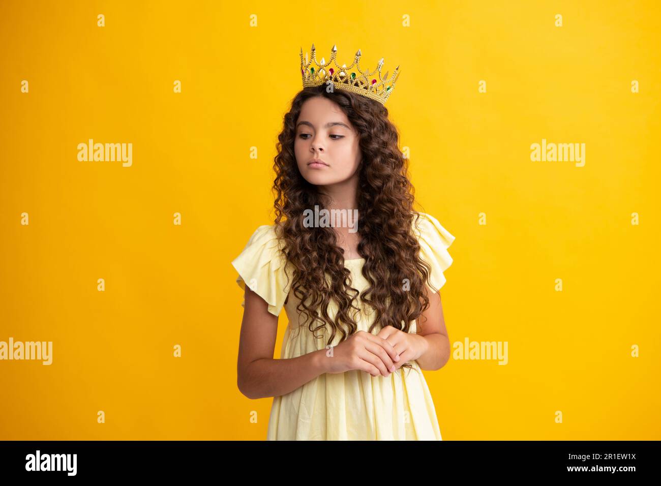 Little queen wearing golden crown. Teenage girl princess holding crown ...