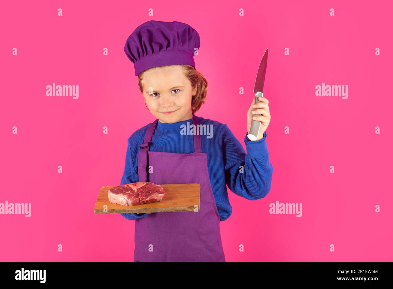 Child cook hold cutting board with meat beef steak and knife. Chef kid ...