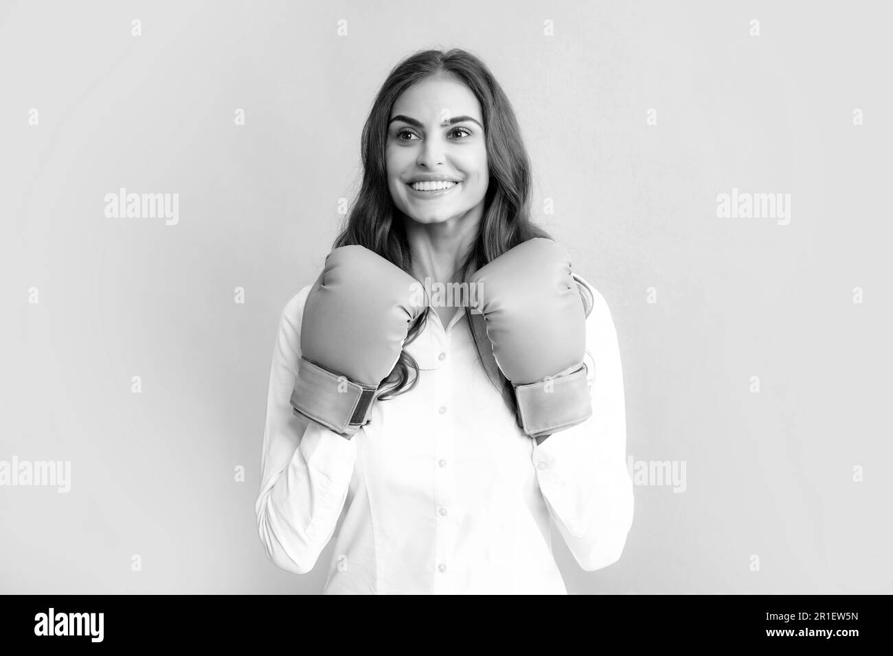 Business woman wearing boxing gloves ready to fight. Strength, power or ...