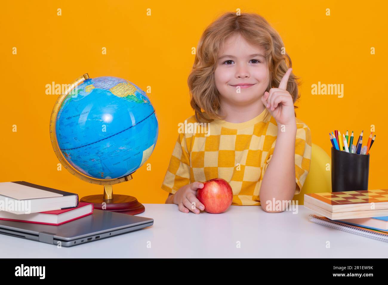 School kid holding index finger up with great new idea. School kid ...