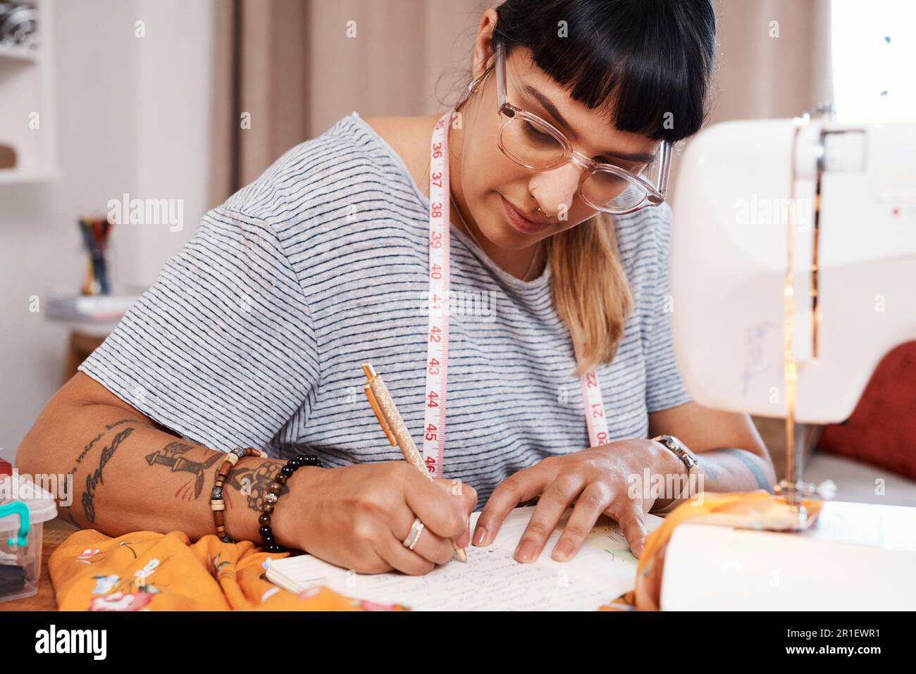 Let me calculate how much fabric Ill need. a young woman designing a ...