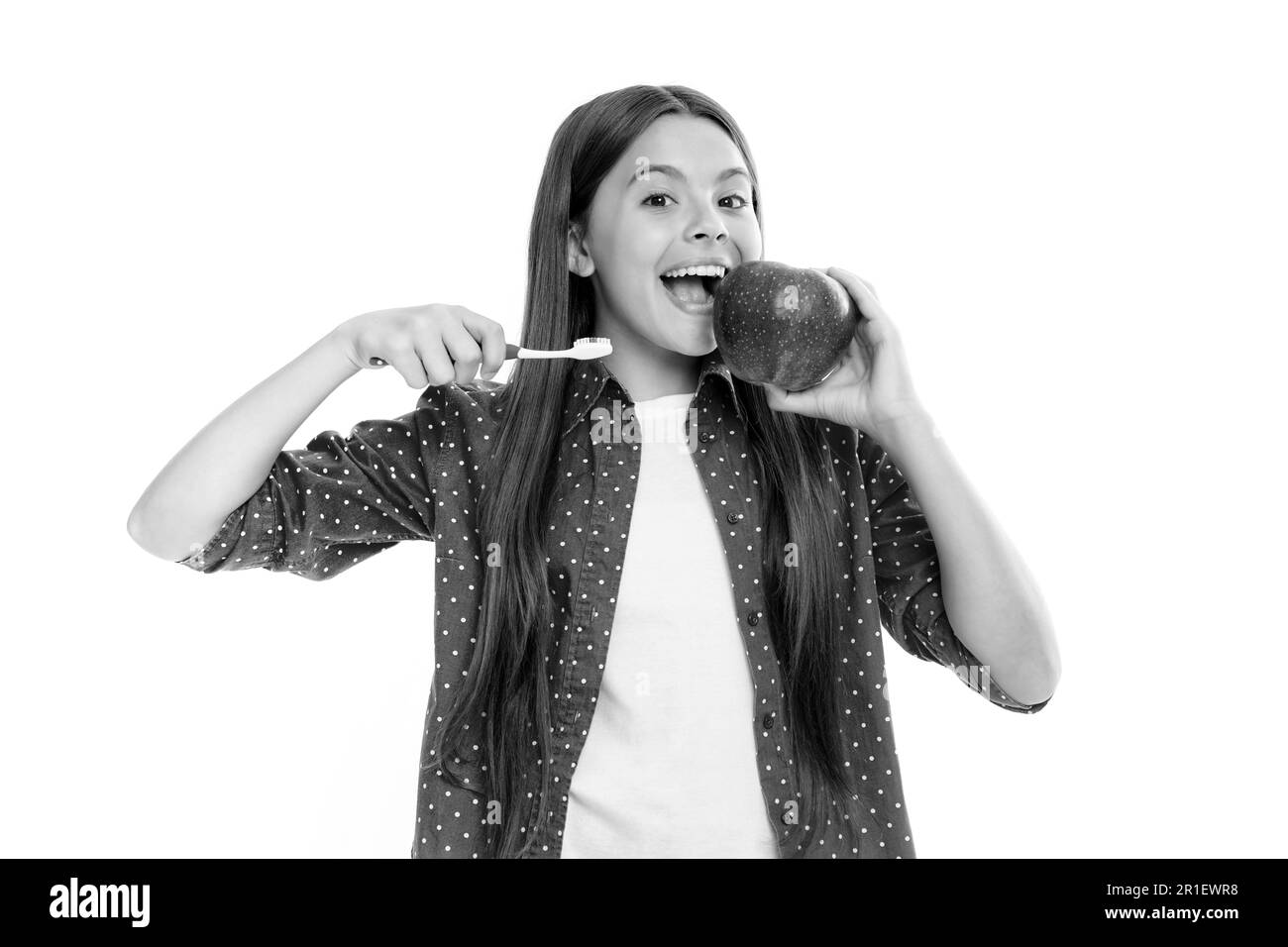 Portrait of caucasian teen girl holds a toothbrush brushing her teeth ...
