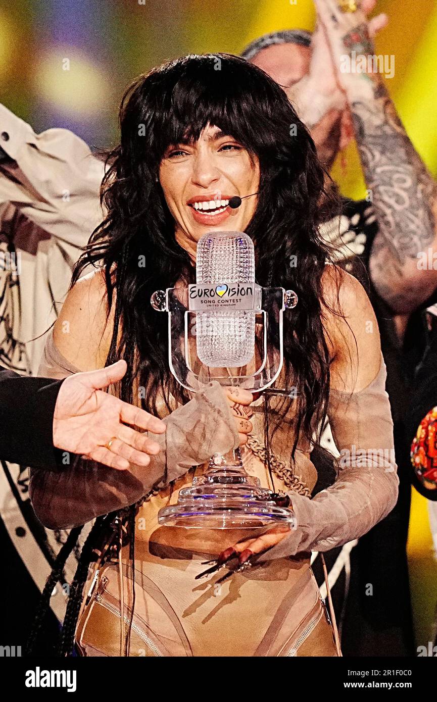 Sweden entrant Loreen is presented with the trophy by Kalush Orchestra ...