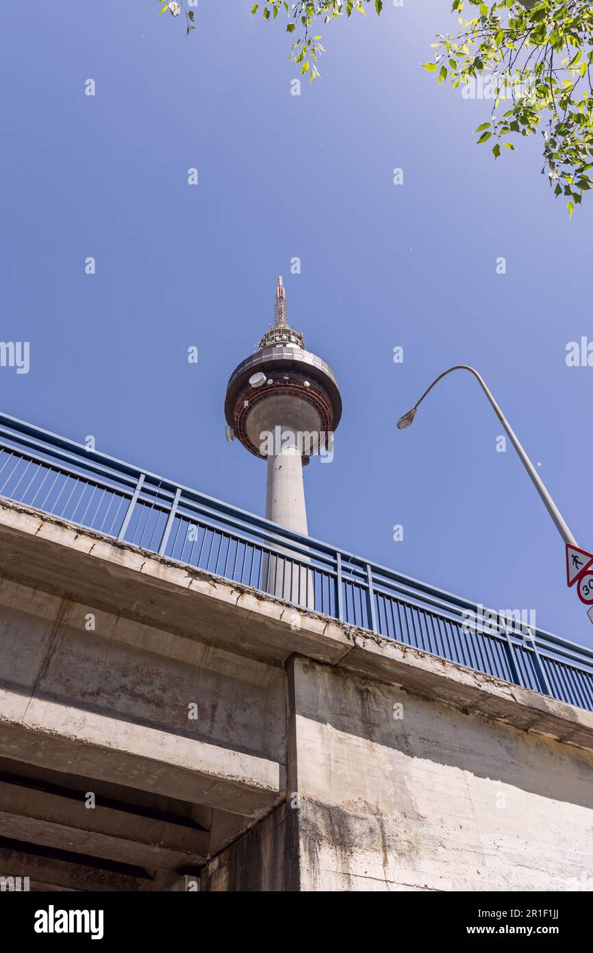 Views of the Madrid telecommunications tower from a low-angle bridge ...