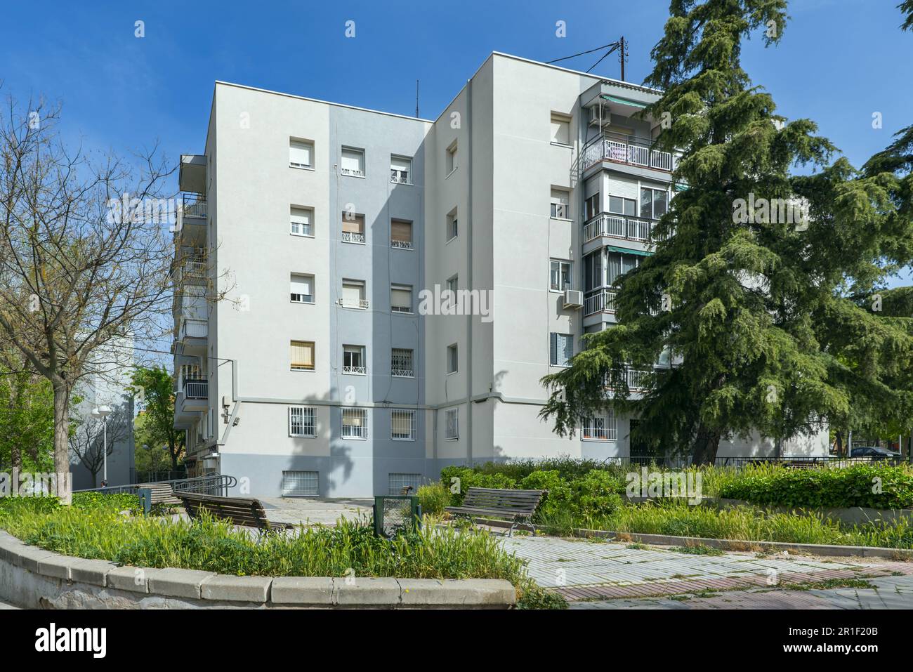 Simple facade of a residential housing building surrounded by large ...