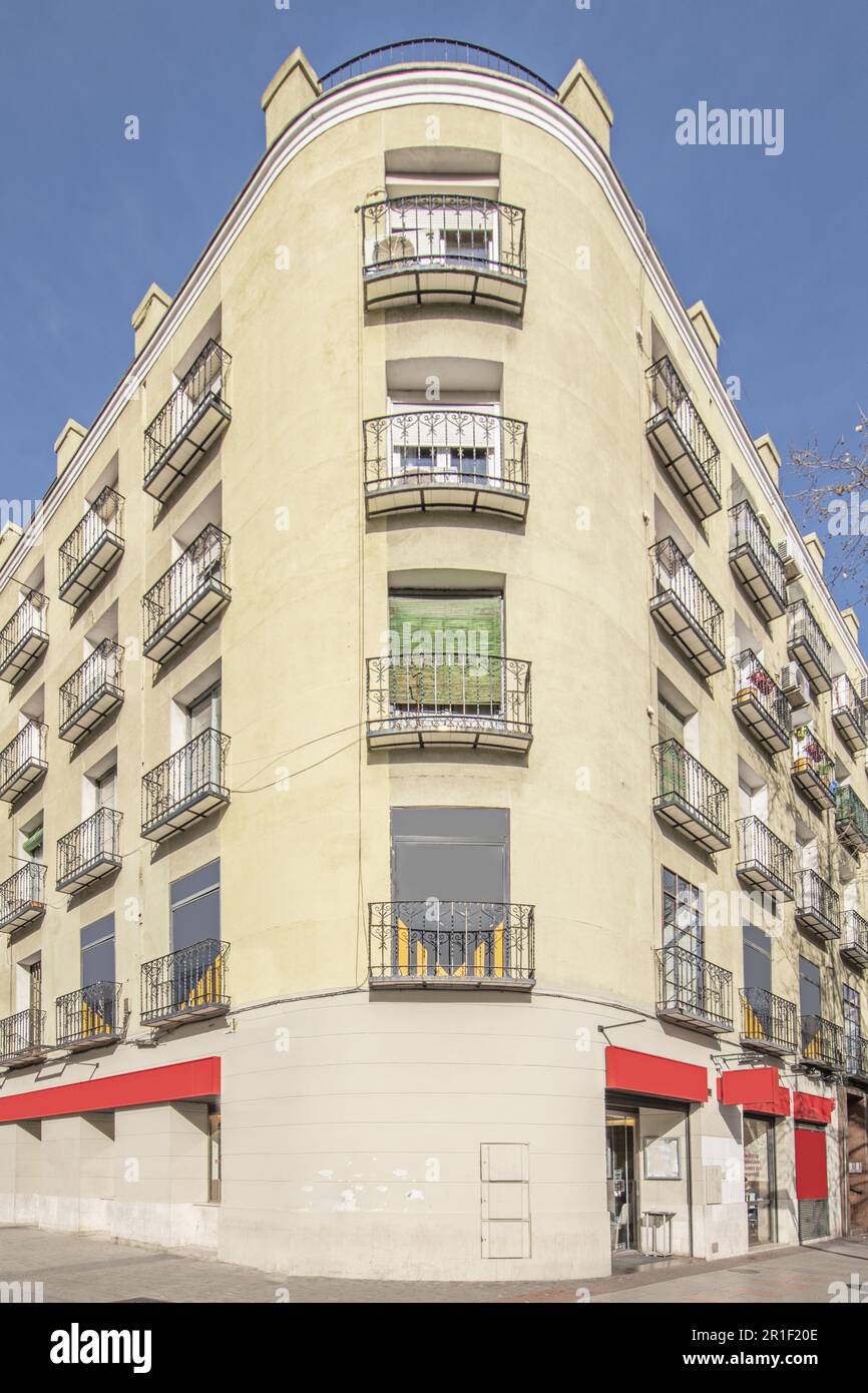 Facade of a four-story residential building with balconies with wrought ...