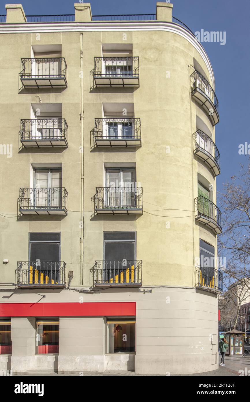 Facade of a four-story residential building with balconies with wrought ...