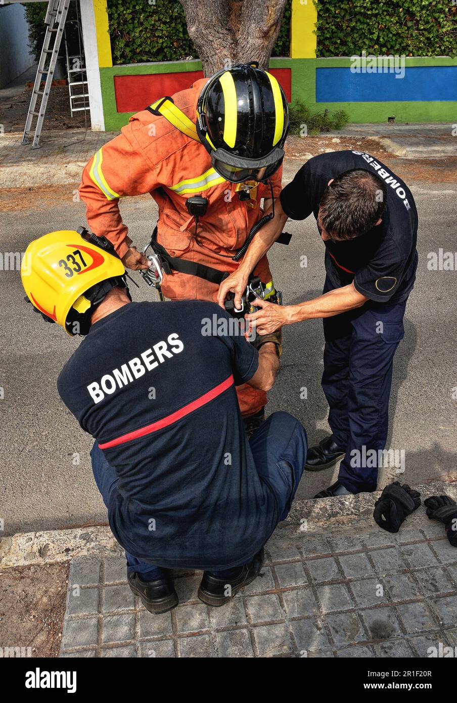 Two firefighters adjusting a partner security belts Stock Photo - Alamy