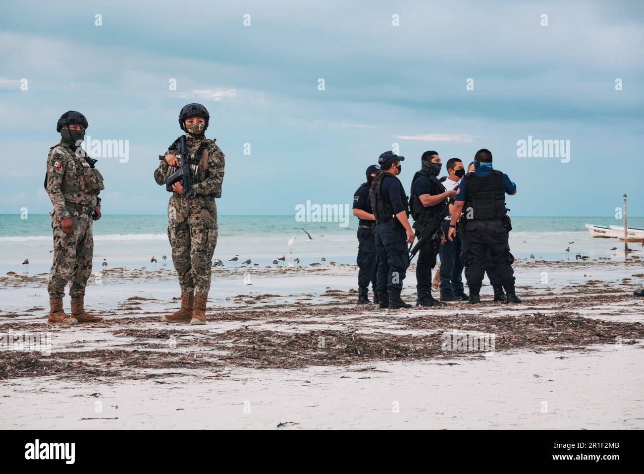 Mexican army soldiers and police conduct an operation on a beach at a ...