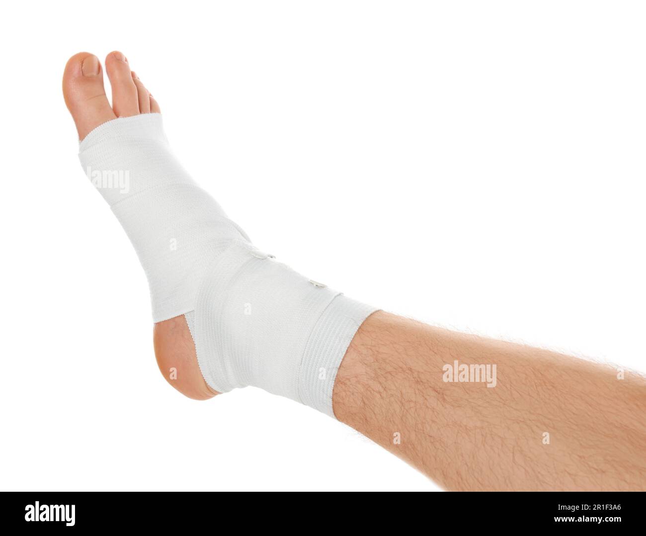 Man with foot wrapped in medical bandage on white background, closeup ...