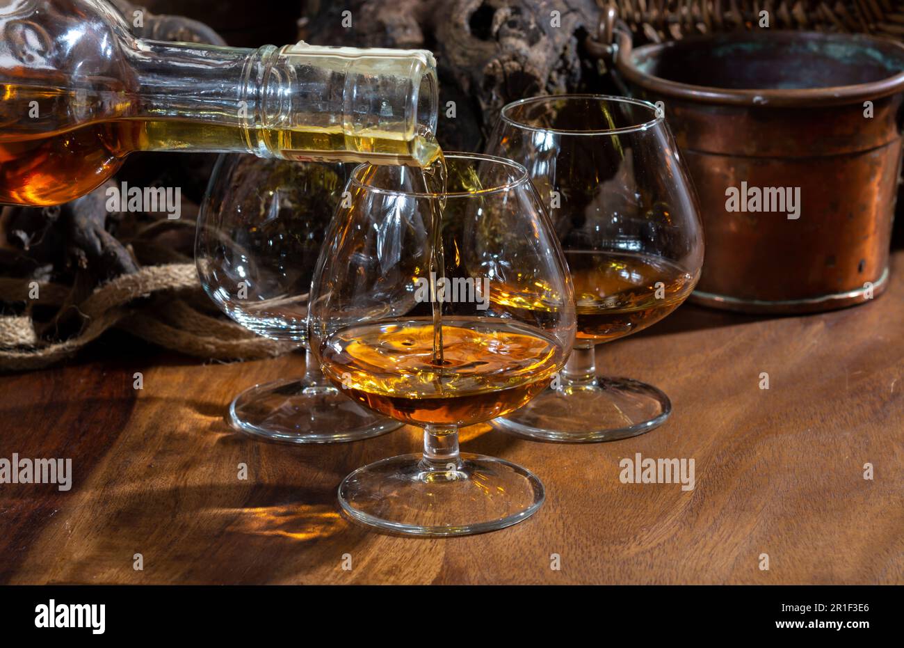 Tasting glasses of aged french cognac brandy alcoholic drink in old ...