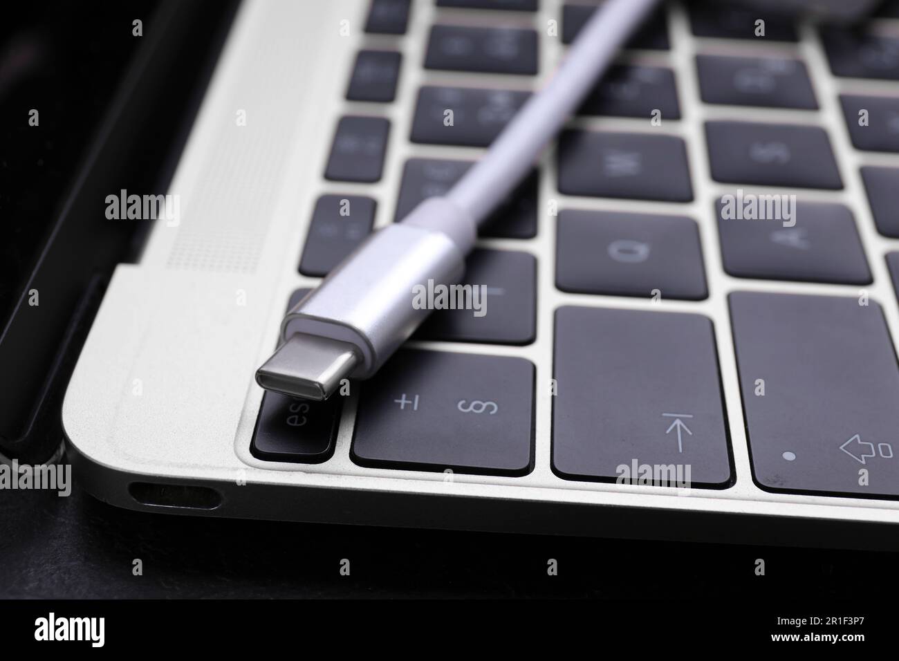 USB cable with type C connector on laptop keyboard, closeup Stock Photo ...