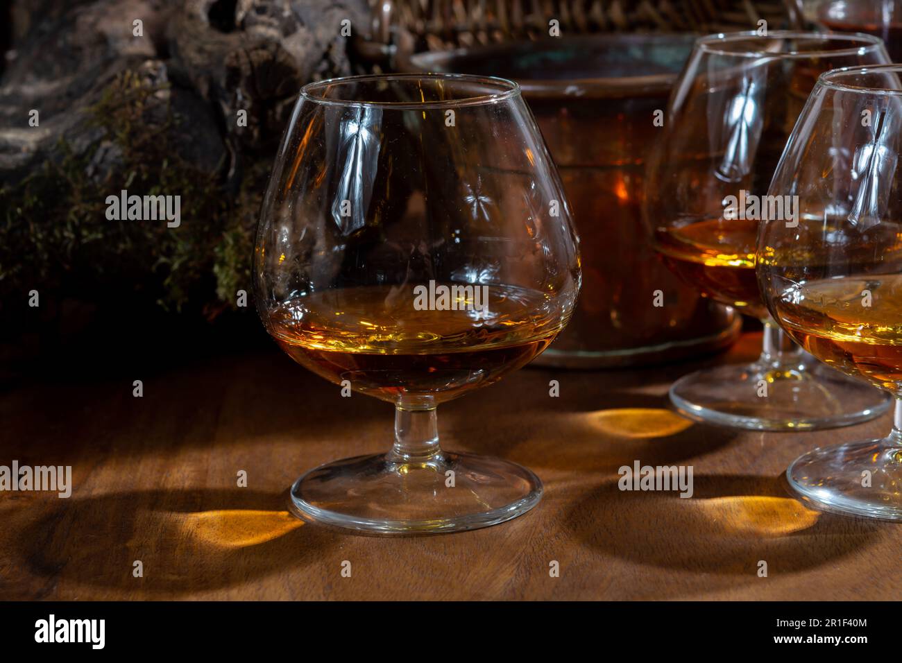 Tasting glasses of aged french cognac brandy alcoholic drink in old ...