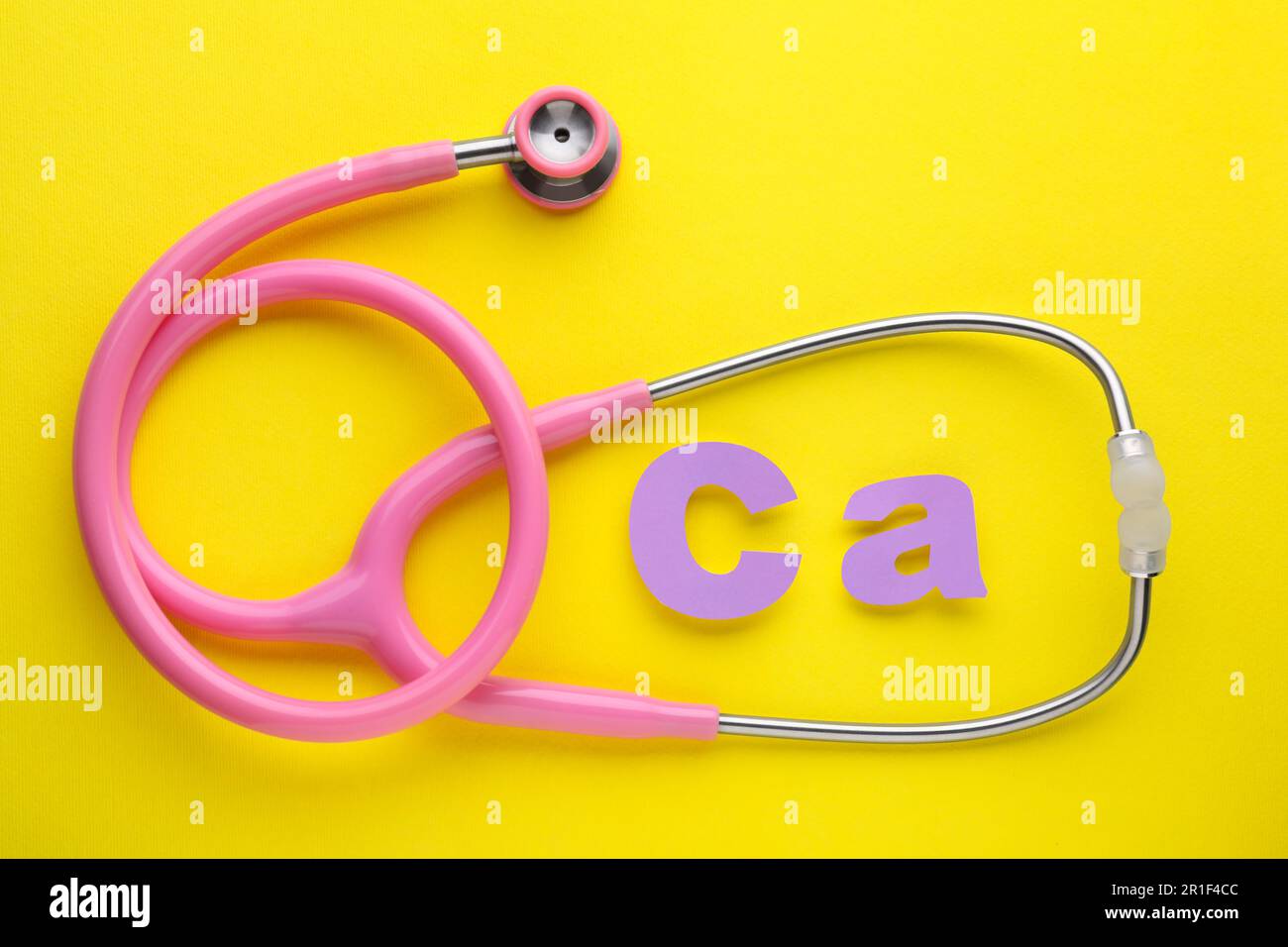Stethoscope and calcium symbol made of purple letters on yellow ...