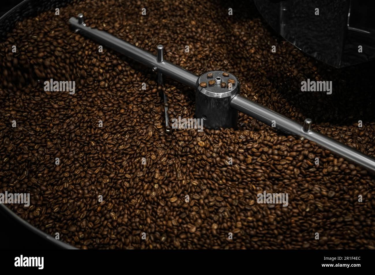 Modern coffee roaster machine with beans, closeup Stock Photo - Alamy