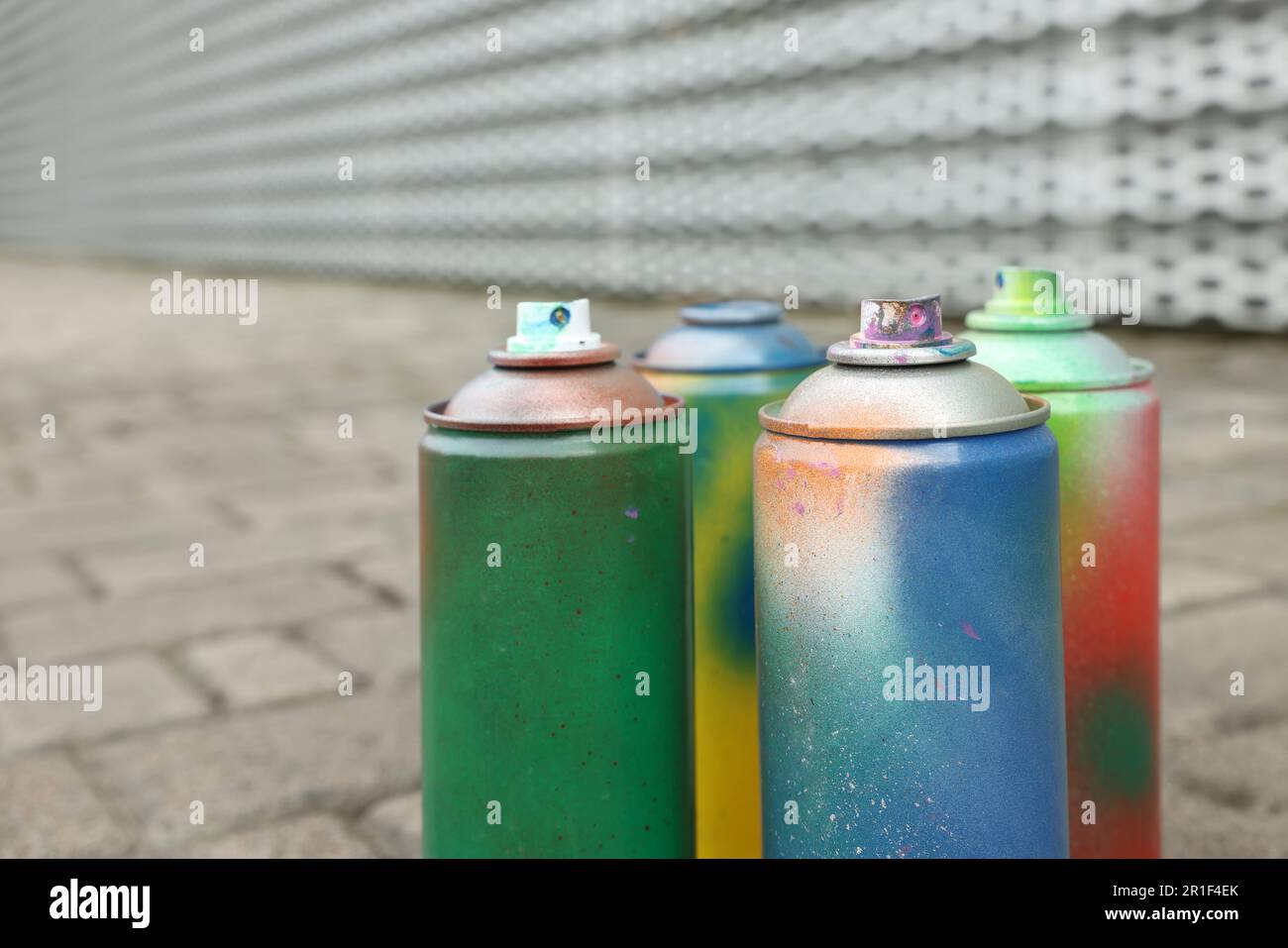 Used cans of spray paints on pavement, closeup Stock Photo - Alamy