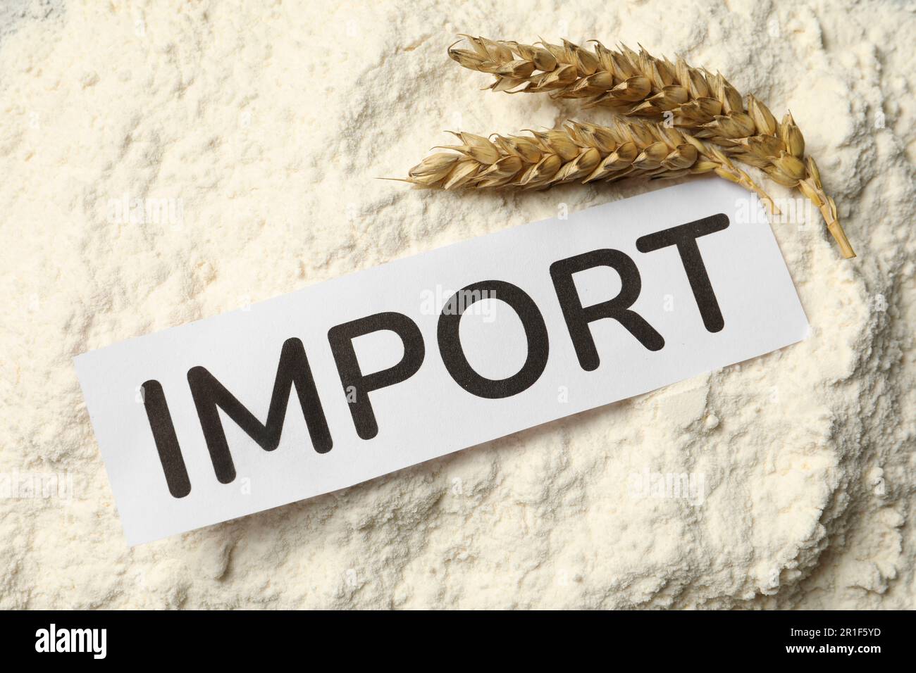 Card with word Import on wheat flour, top view Stock Photo - Alamy