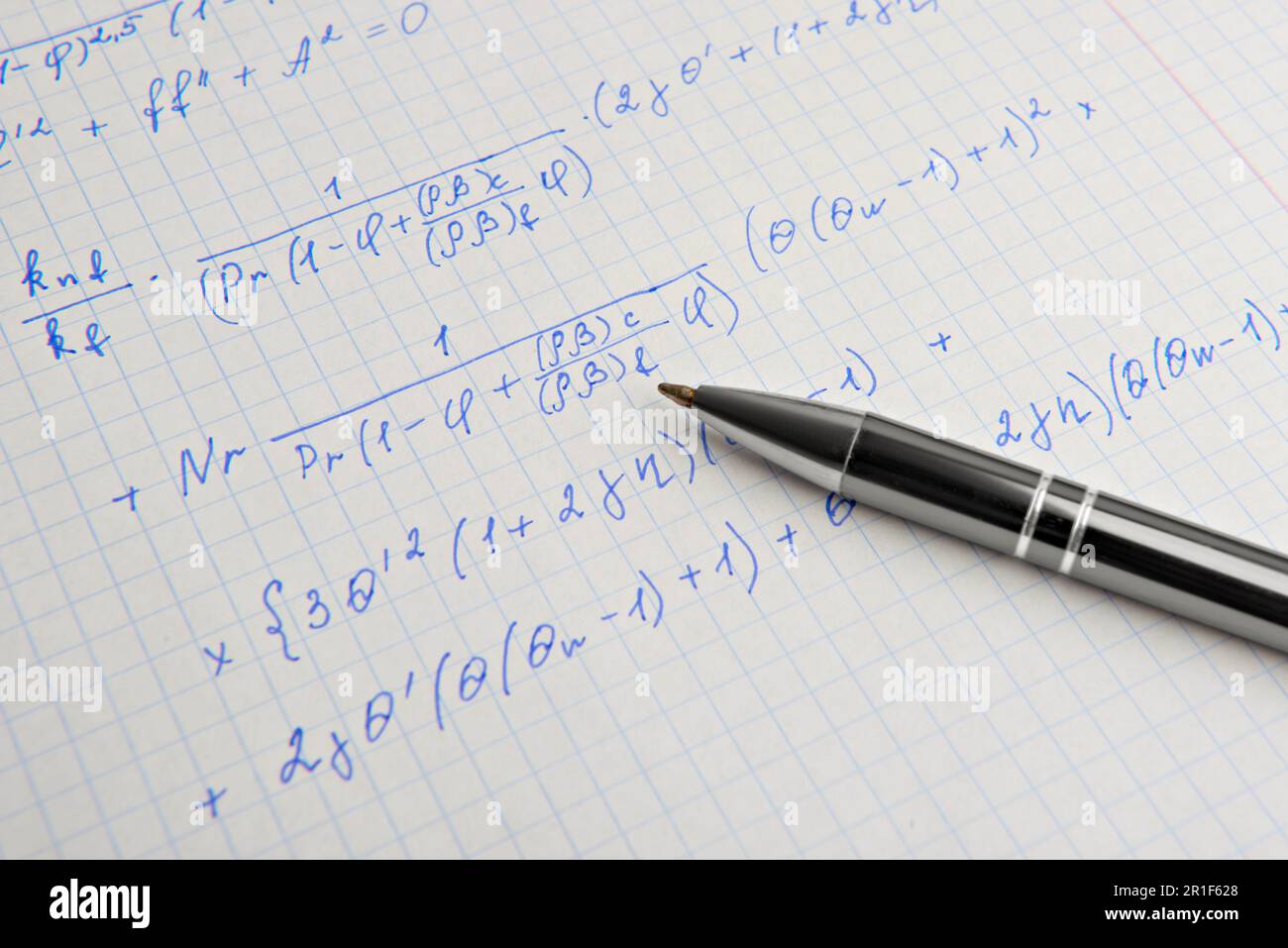 Paper with written mathematical calculations and pen, closeup Stock ...