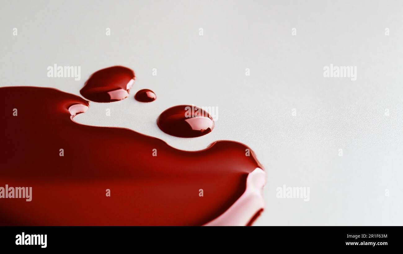 Stain and drops of blood on light grey background, closeup. Space for ...