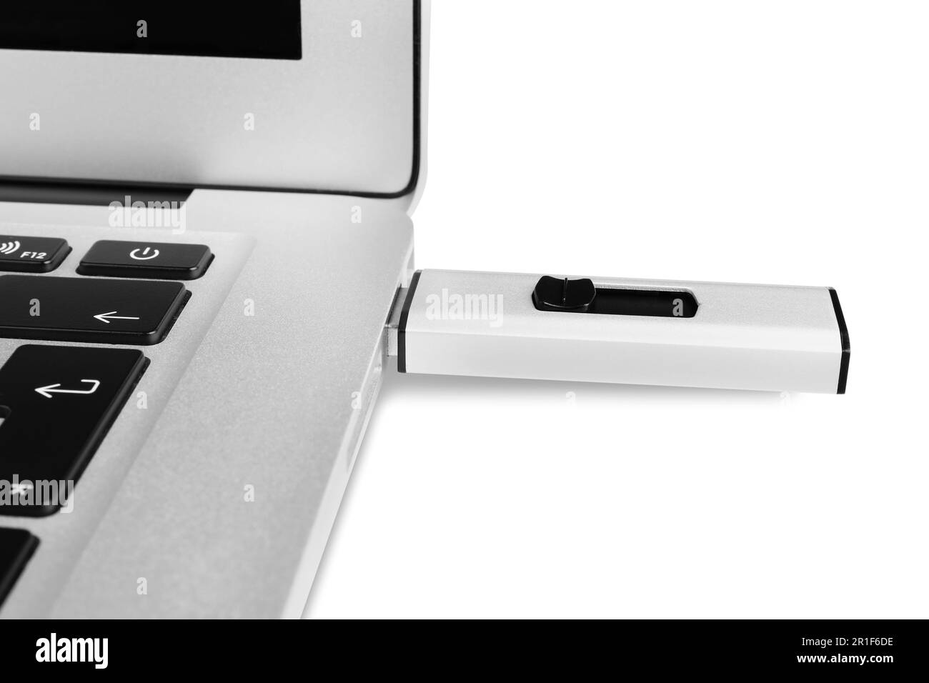 Modern usb flash drive attached into laptop on white background ...
