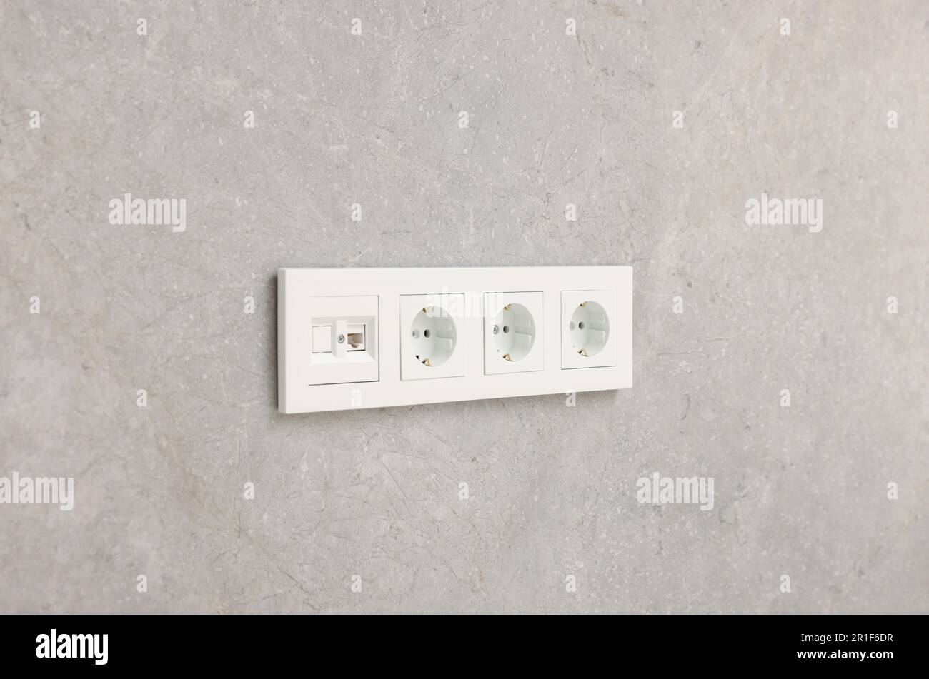 Wall with power outlet sockets in room. Interior design Stock Photo - Alamy