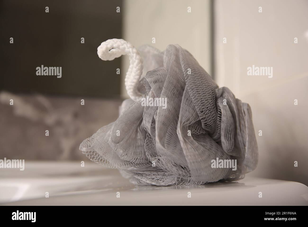 Grey shower puff on washbasin in bathroom, closeup Stock Photo - Alamy