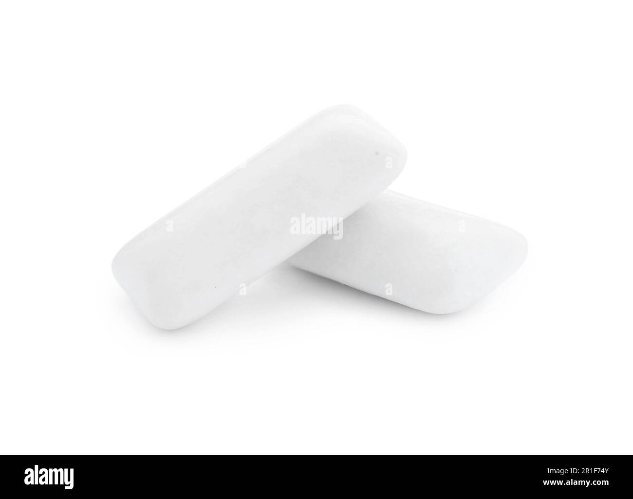 Two pieces of chewing gum on white background Stock Photo - Alamy