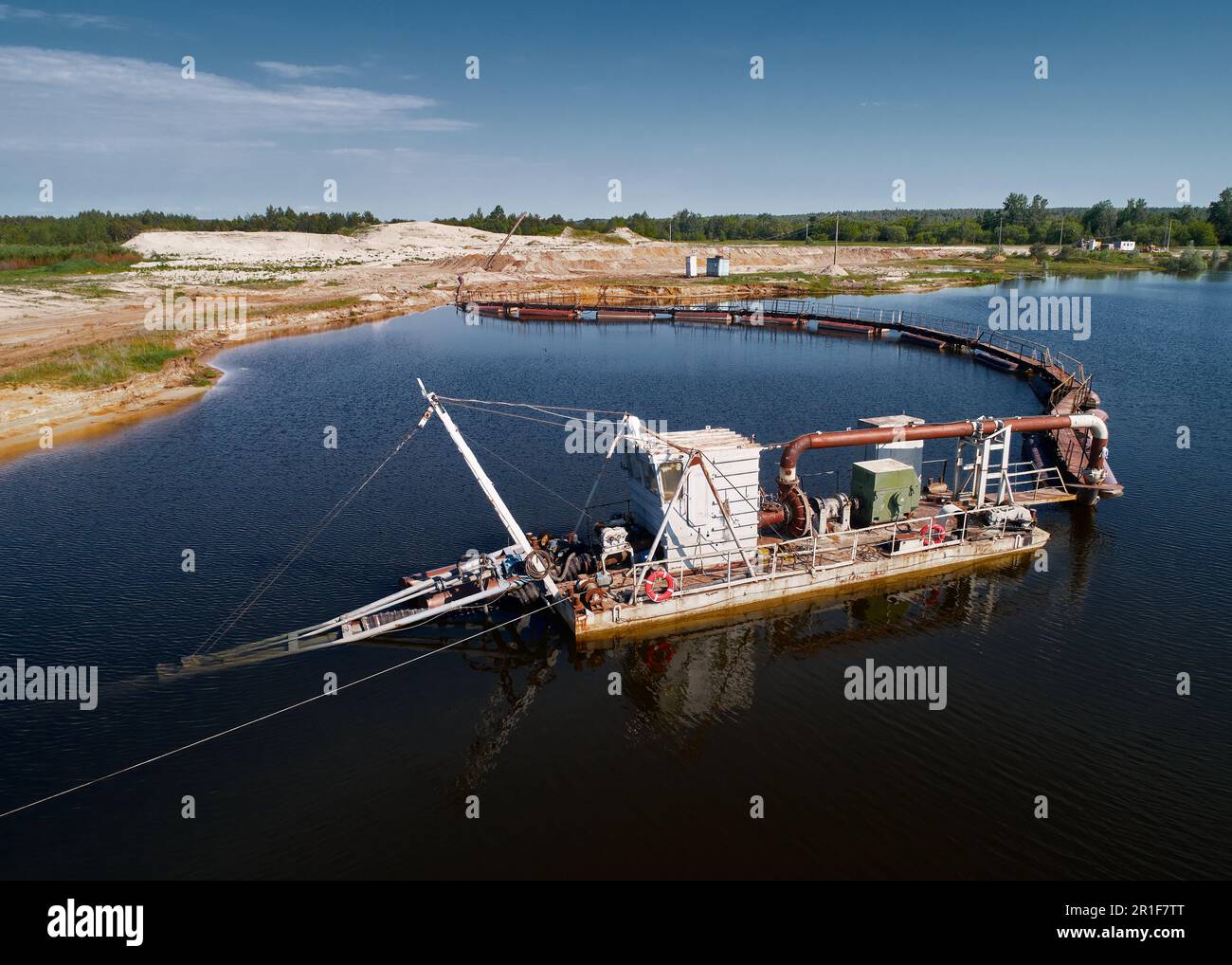 Trailing suction hopper dredger draws up bottom mud on river Stock ...