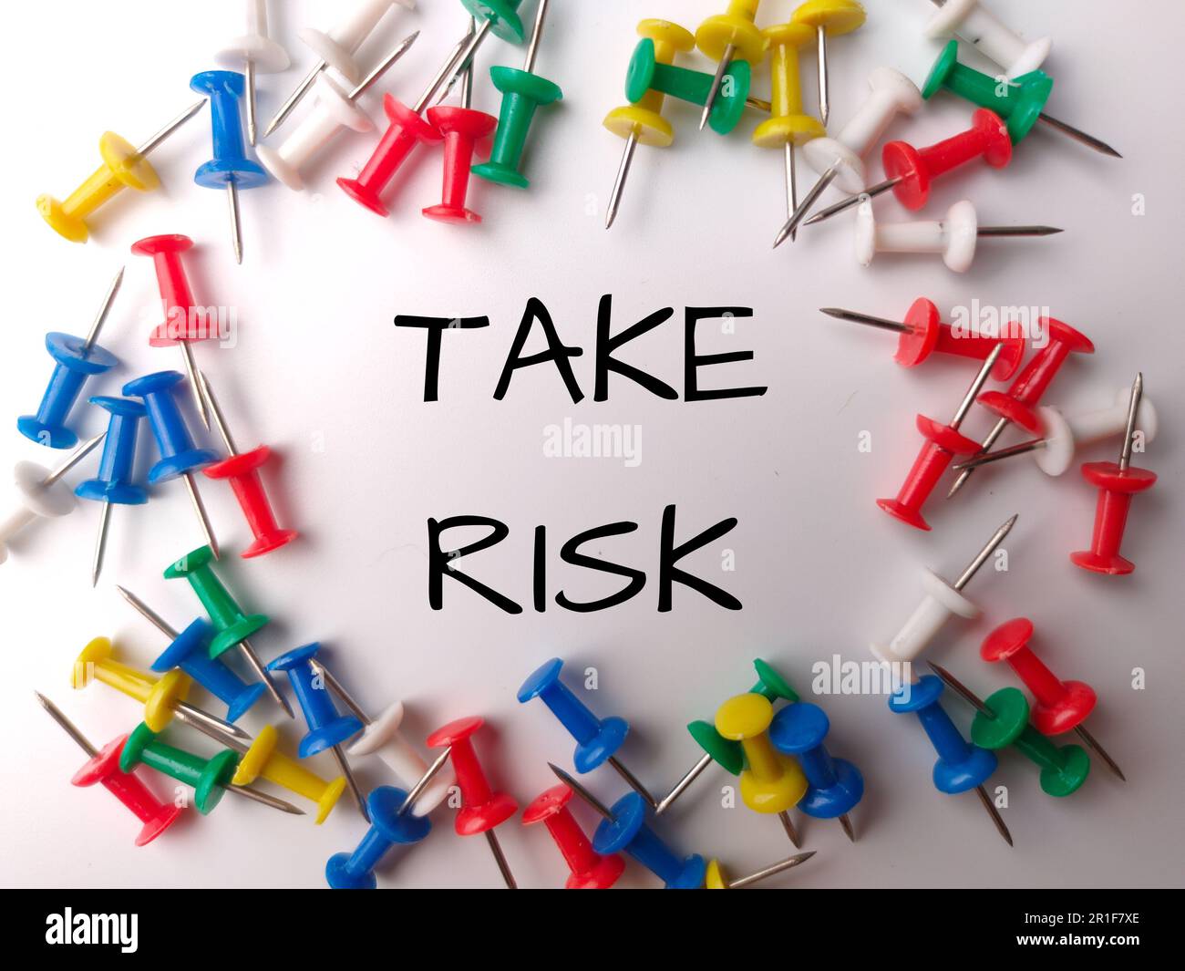 Colorful push pin with the word TAKE RISK on white background Stock ...