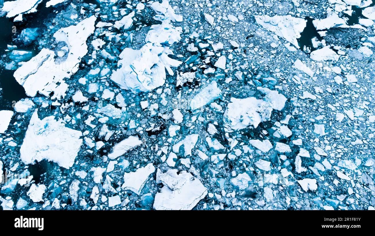 Melting Arctic ice in ocean water. Snow covered Blue glacier ice in ...