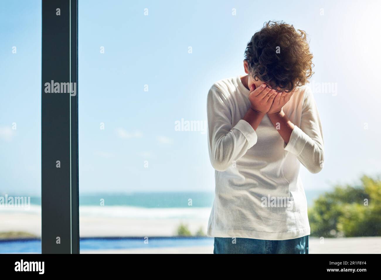 Sad, depression and crying child with hands covering face while lonely ...