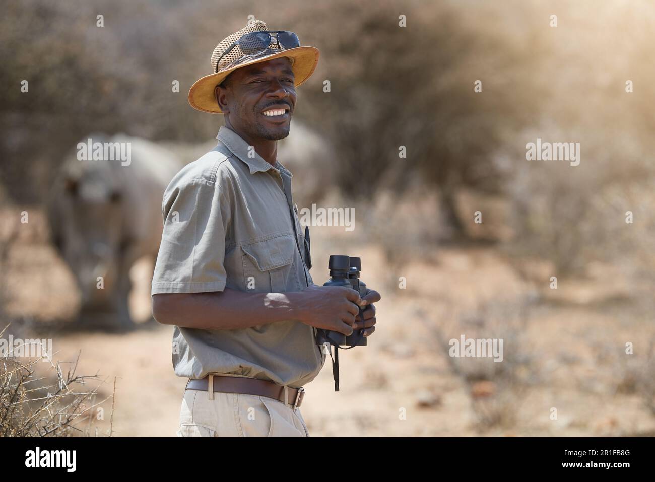 Portrait, safari and wildlife with a man ranger outdoor in a game park ...