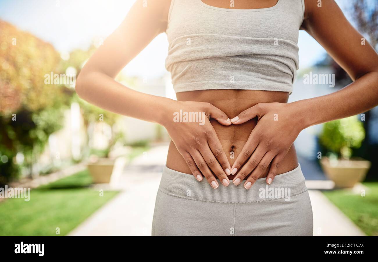 Hands of woman on stomach in park, gut health and fitness for lipo ...