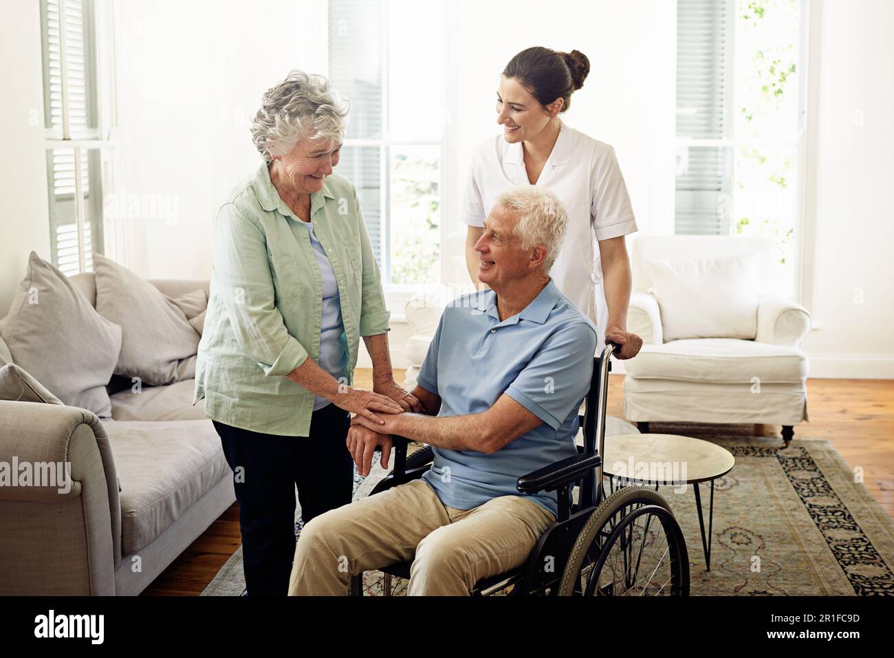 Smile, old man in wheelchair with wife and nurse at nursing home for ...