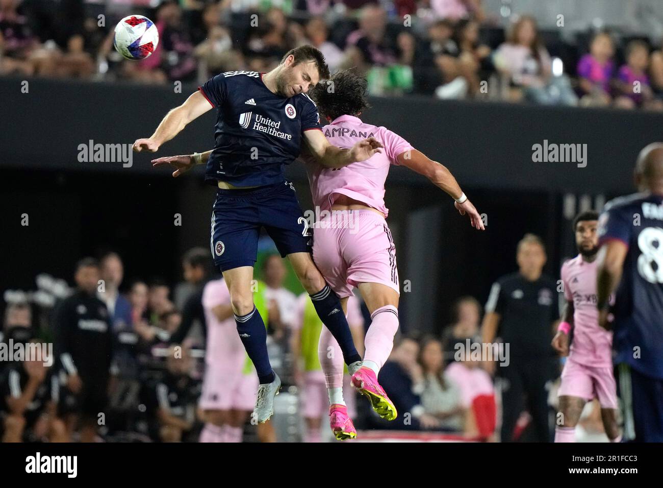 New England Revolution defender Dave Romney (2) heads the ball next to ...