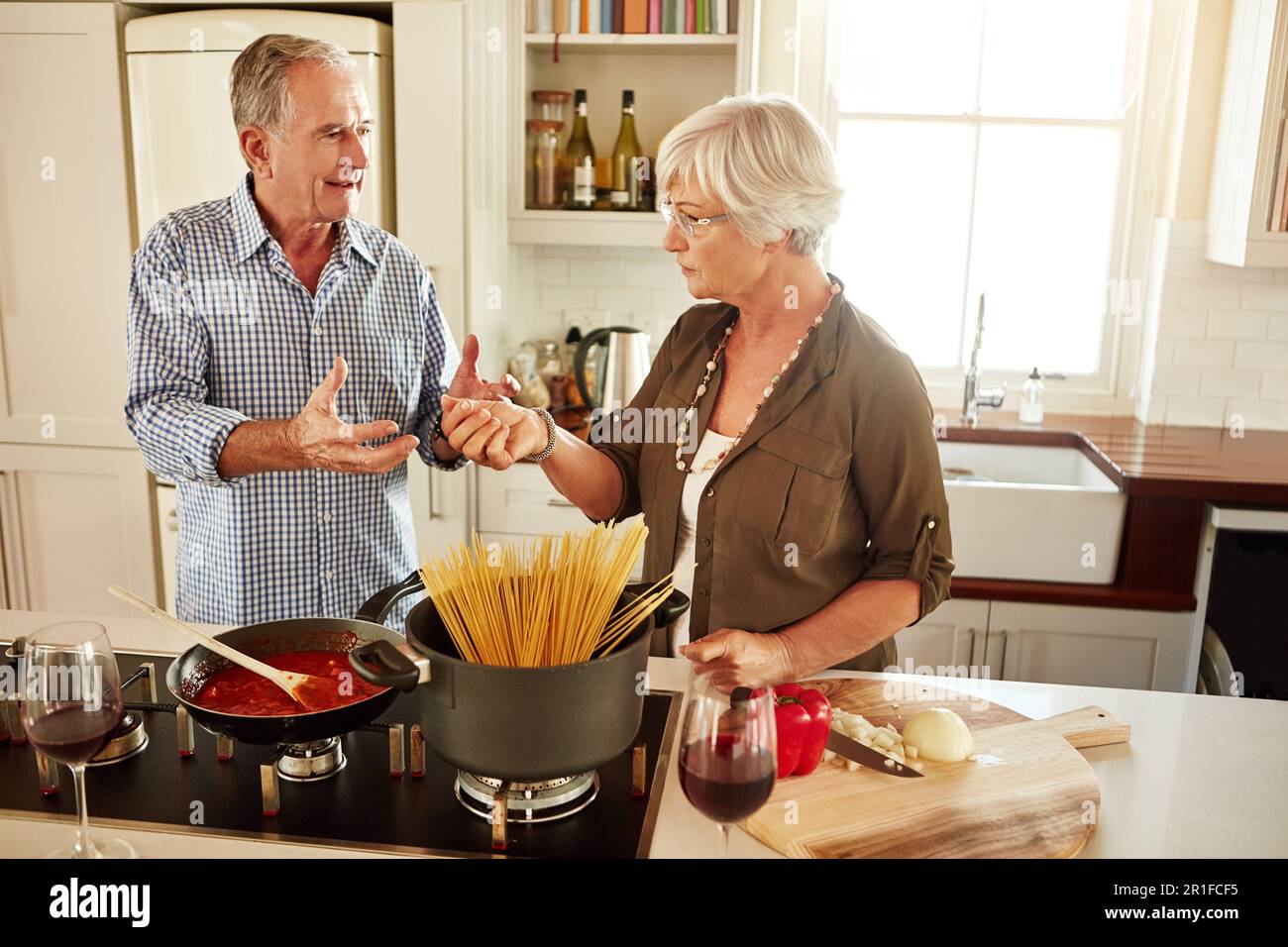 Mature woman talking kitchen hi-res stock photography and images - Alamy