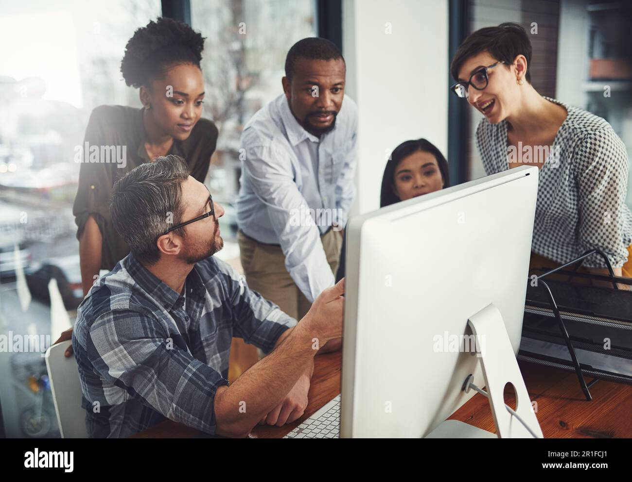 Teamwork, computer and coaching with business people in meeting for ...