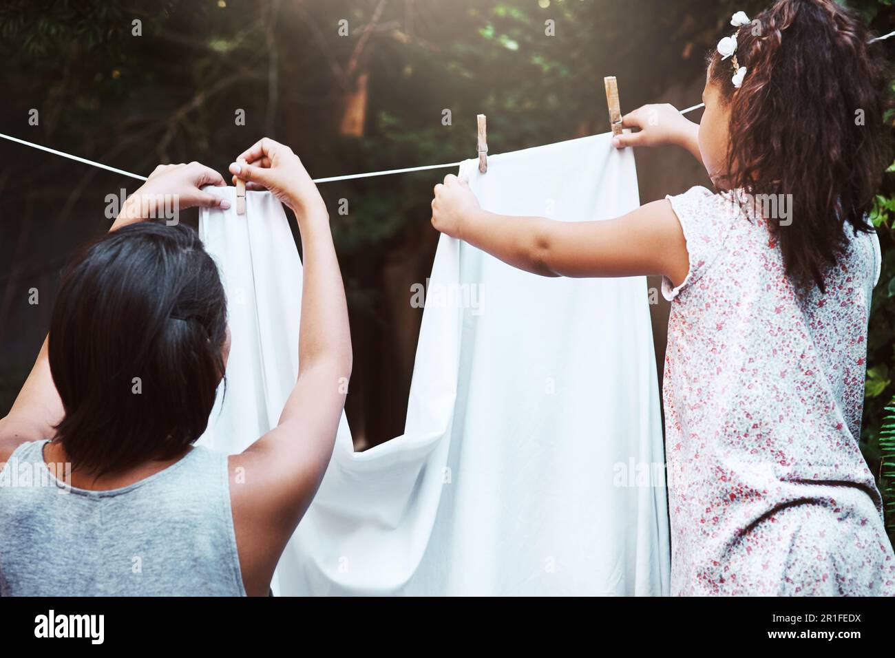 Help, hanging laundry and a mother and child doing housework, chores ...