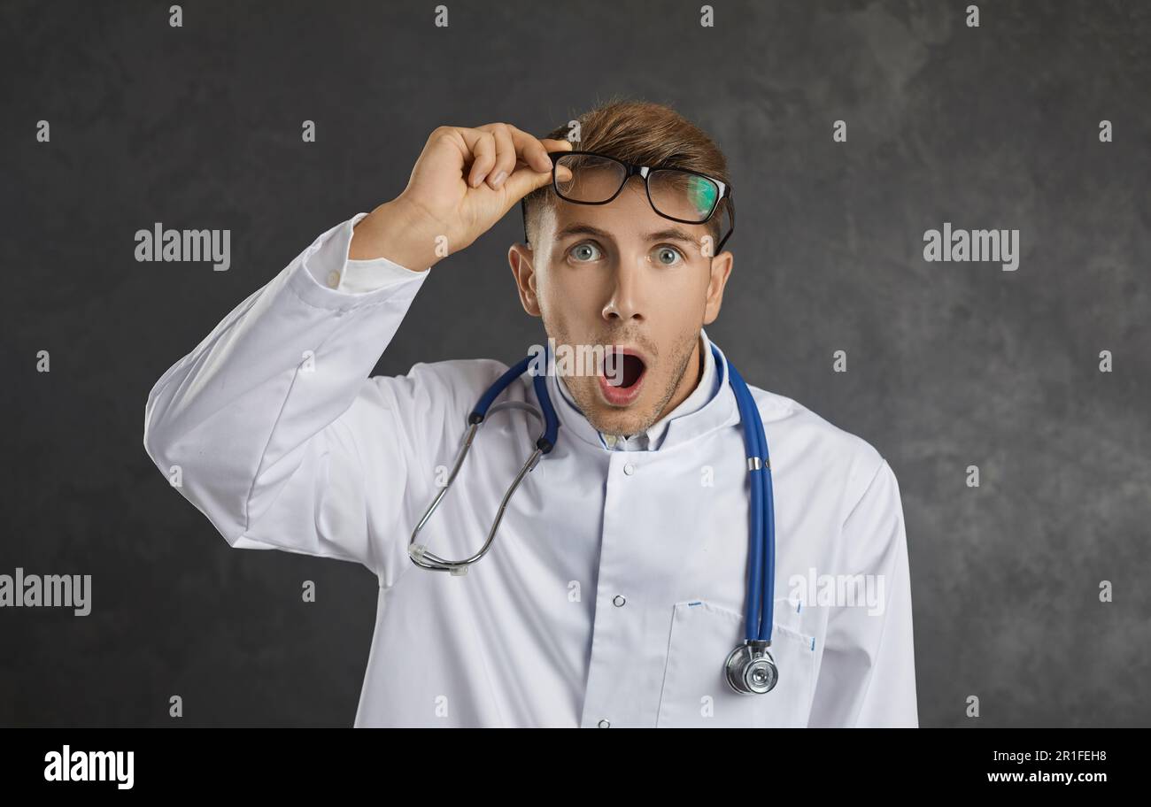 Portrait of stunned male doctor shocked by news Stock Photo - Alamy