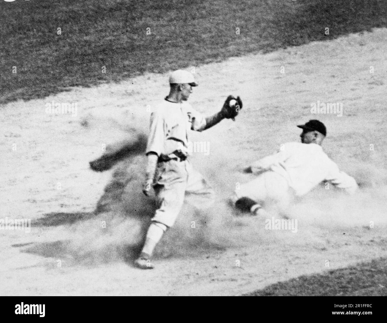 Archival Photo: Ball player sliding into base as fielder reaches to ...
