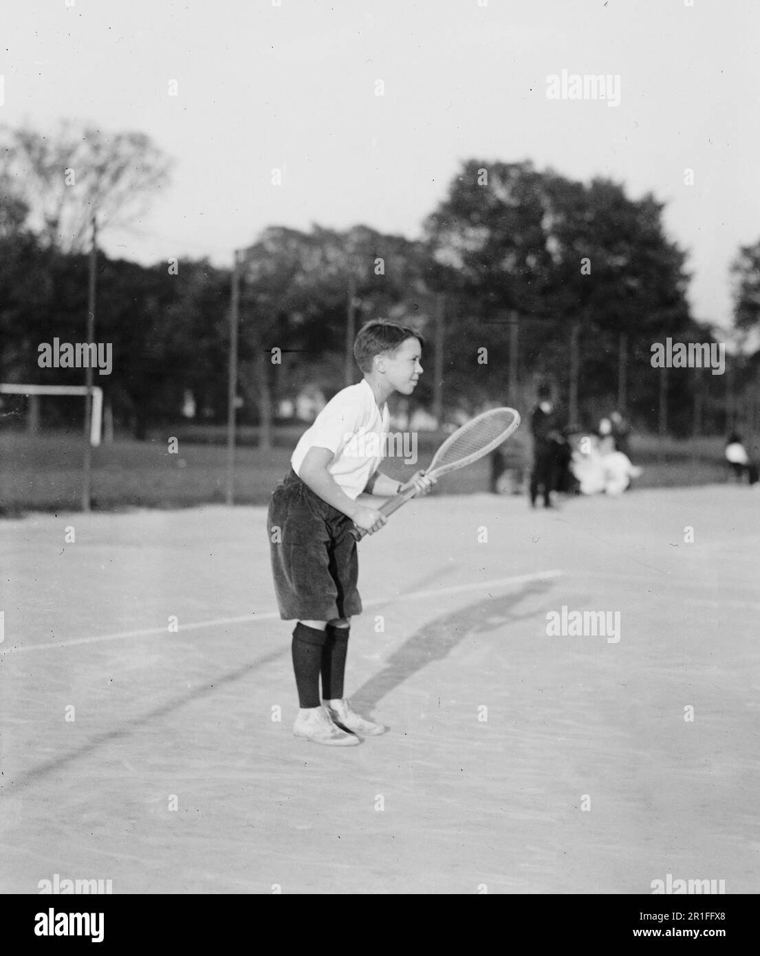 Archival Photo: A boy awaiting a serve on a tennis court ca. 1918-1920 Stock Photo - Alamy