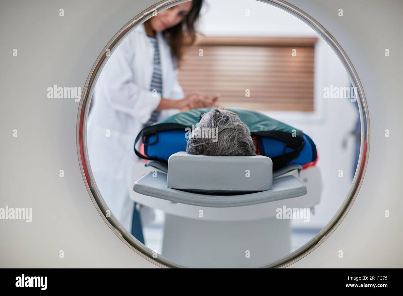 Doctor, ct scan and woman comfort patient in hospital before scanning ...
